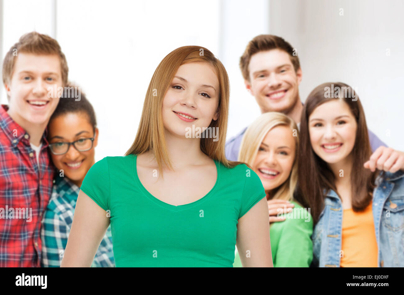 group of smiling teenagers over classroom Stock Photo - Alamy