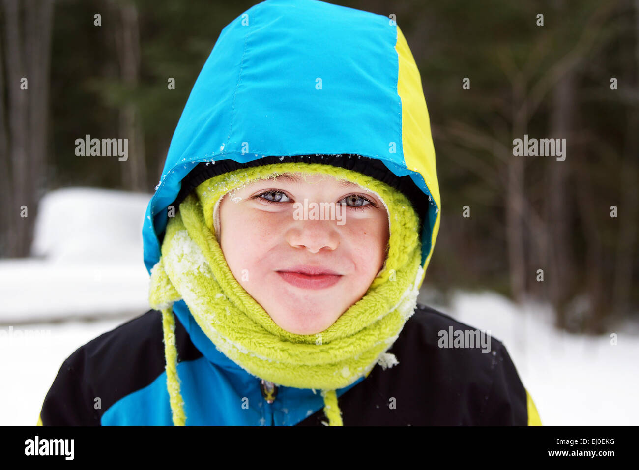 Cute boy playing outside in the woods on cold winter day Stock Photo ...