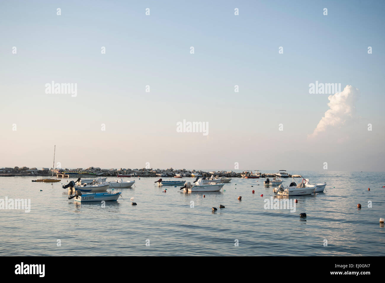 small boats on an Azure blue tranquil sea Stock Photo - Alamy