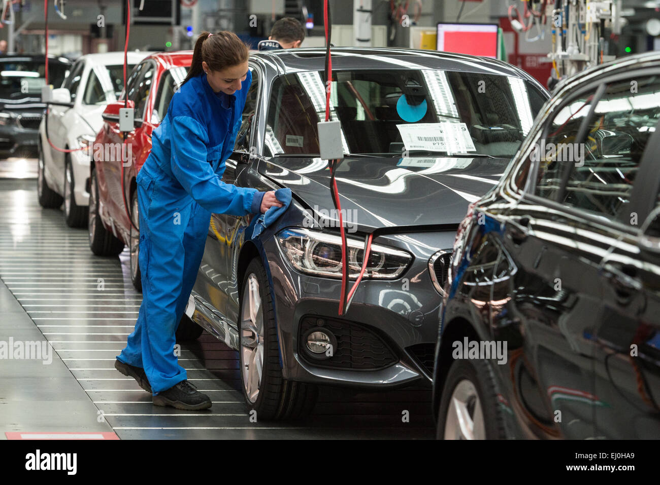 A staff member works on the finishing touches of a car model of the BMW ...