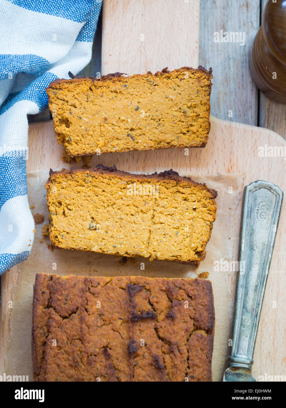 Vertical photo of a loaf of homemade vegetarian chickpea pate on a ...