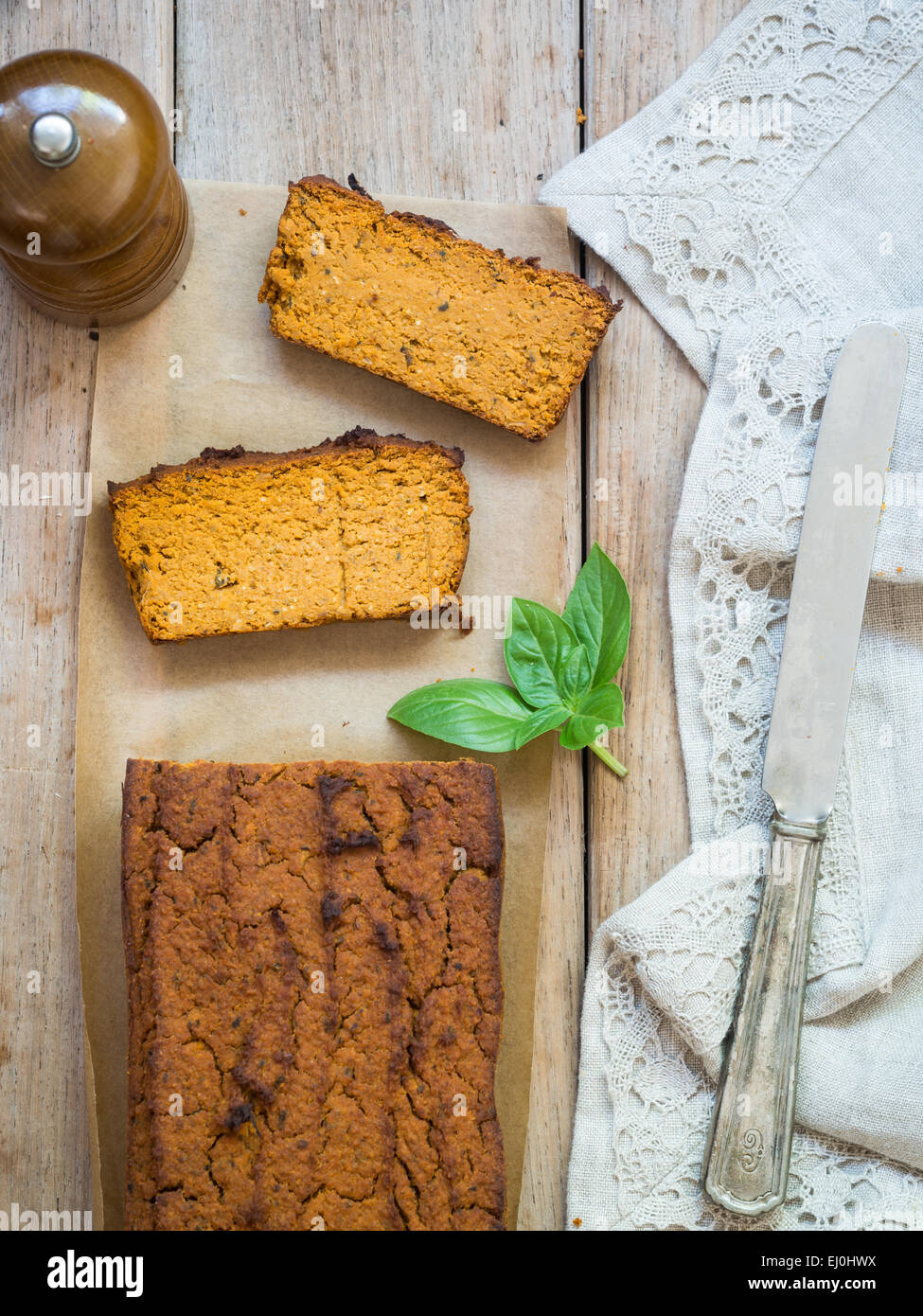 Vertical photo of a loaf of homemade vegetarian chickpea pate on a ...