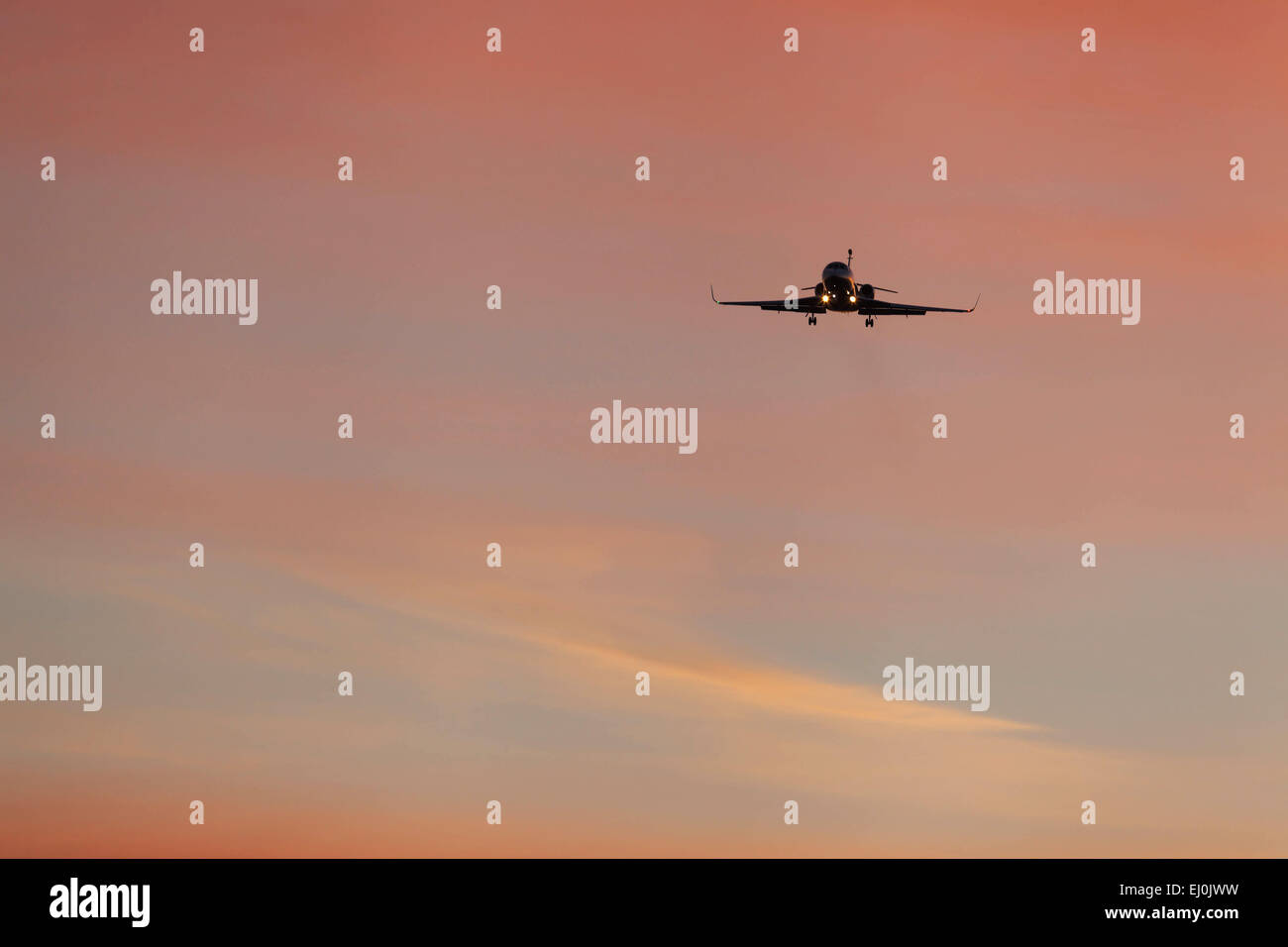 Plane landing in sunset (red sky Stock Photo - Alamy