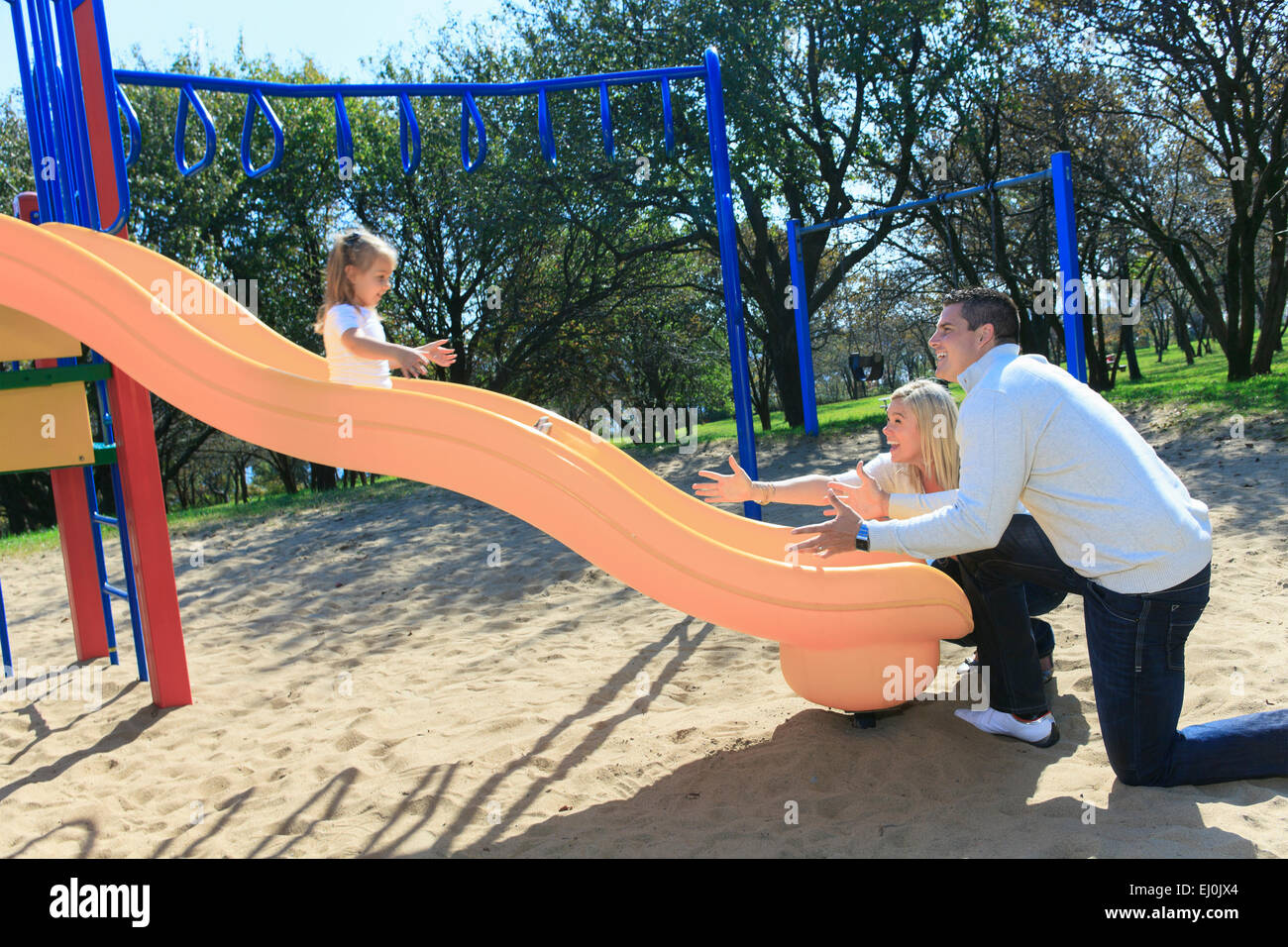 playing on a slide Stock Photo - Alamy