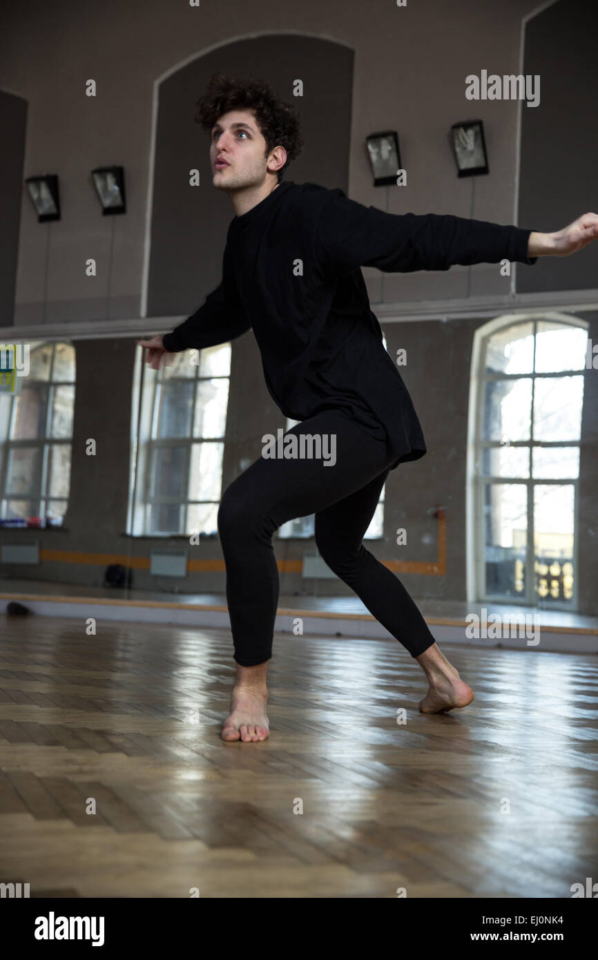 Young man with curly hair dancing at gym Stock Photo - Alamy