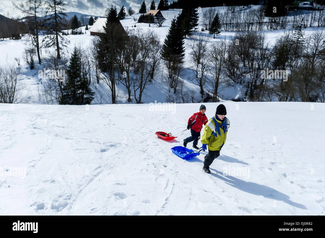 Boys in snow on sled hi-res stock photography and images - Alamy