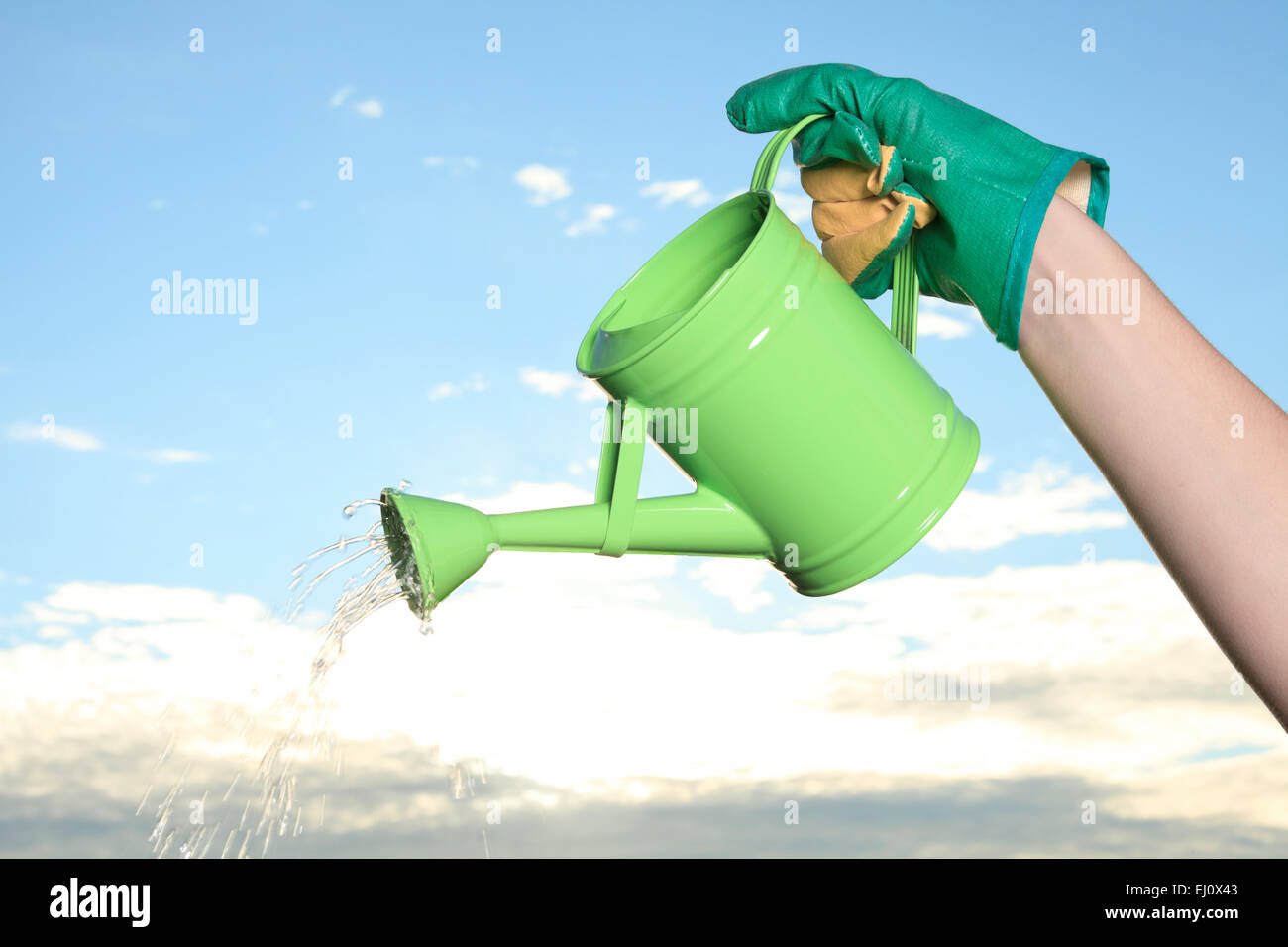 Green watering can on the hand of a girl Stock Photo - Alamy
