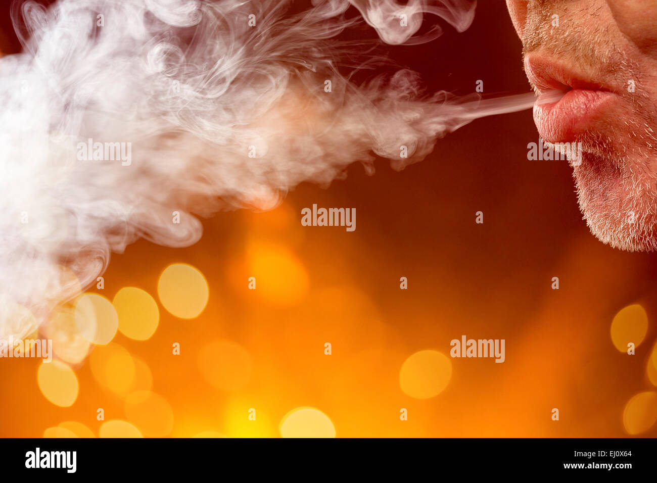 male mouth is blowing smoke out, with bokeh background Stock Photo - Alamy