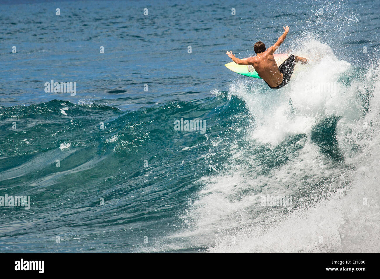 Extreme surfer riding giant ocean wave in Hawaii Stock Photo - Alamy