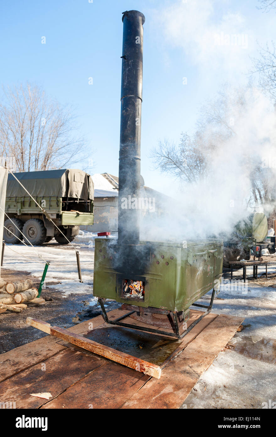 Cooking food on a military field kitchen in field conditions Stock ...