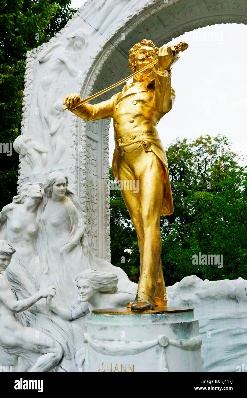 A golden coloured statue of Johann Strauss playing a violin, Vienna ...