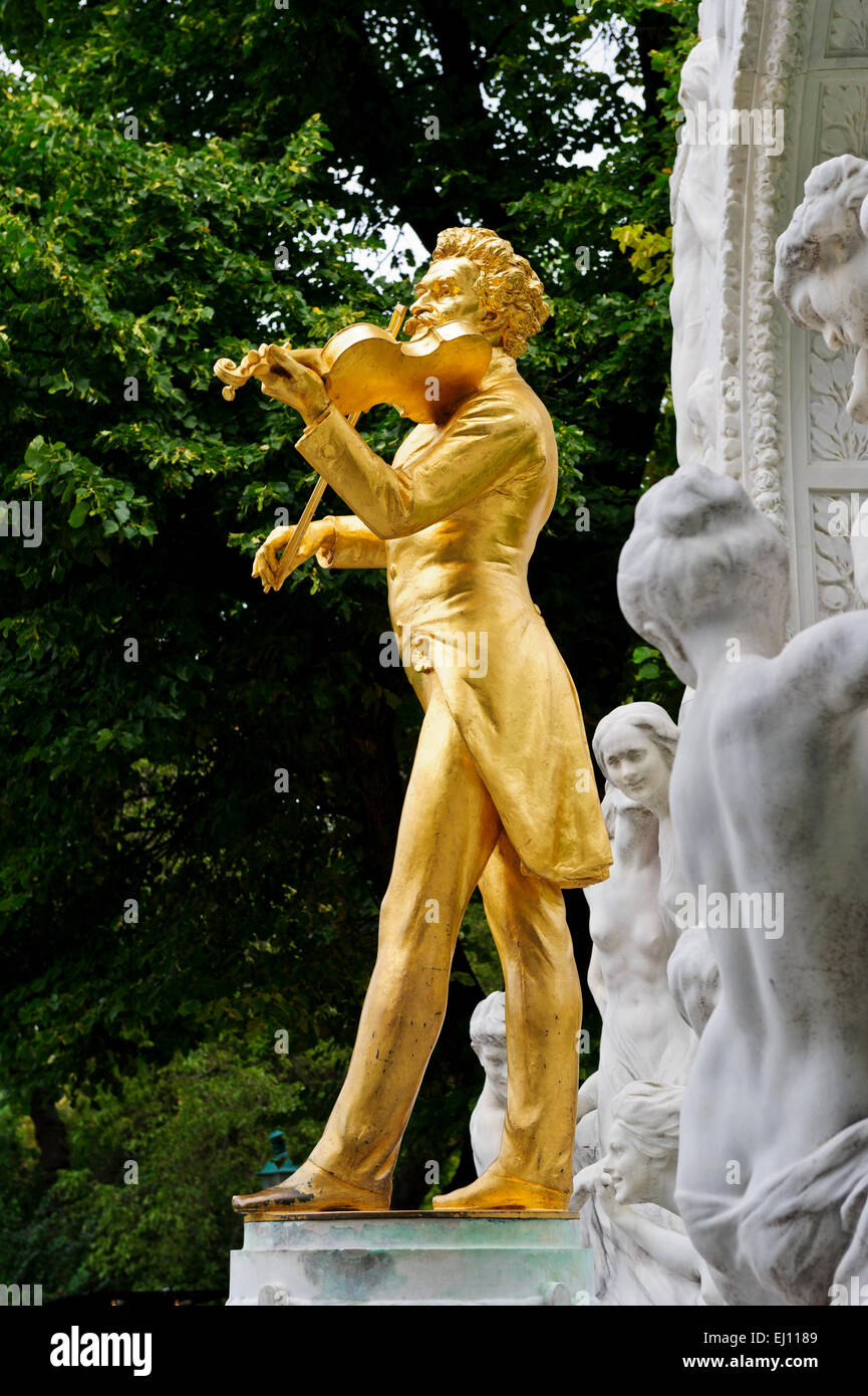 A golden coloured statue of Johann Strauss playing a violin, Vienna ...