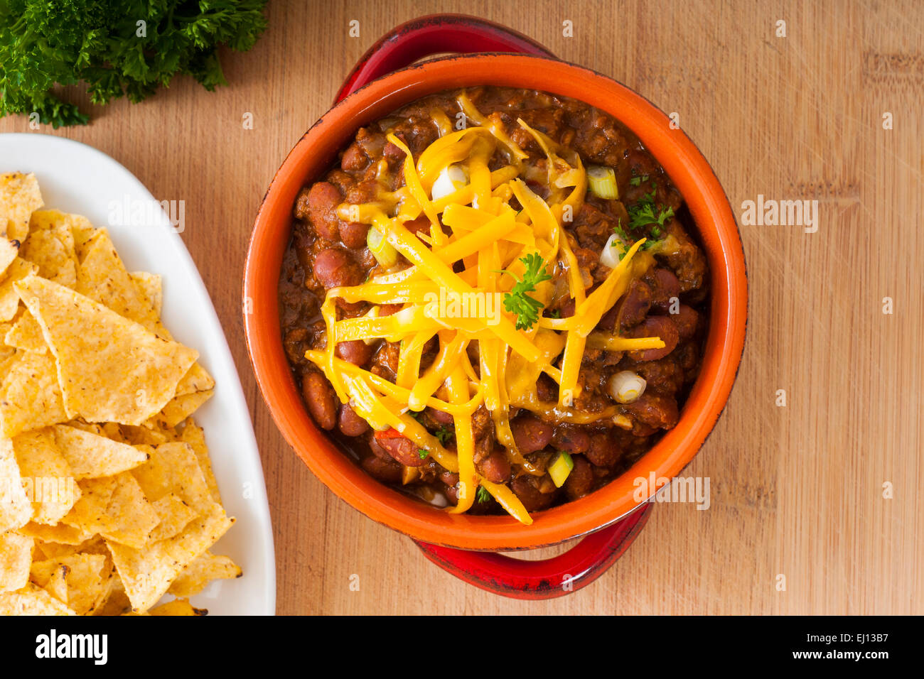 Beef and bean Mexican chili with nacho chips and cheddar cheese Stock ...
