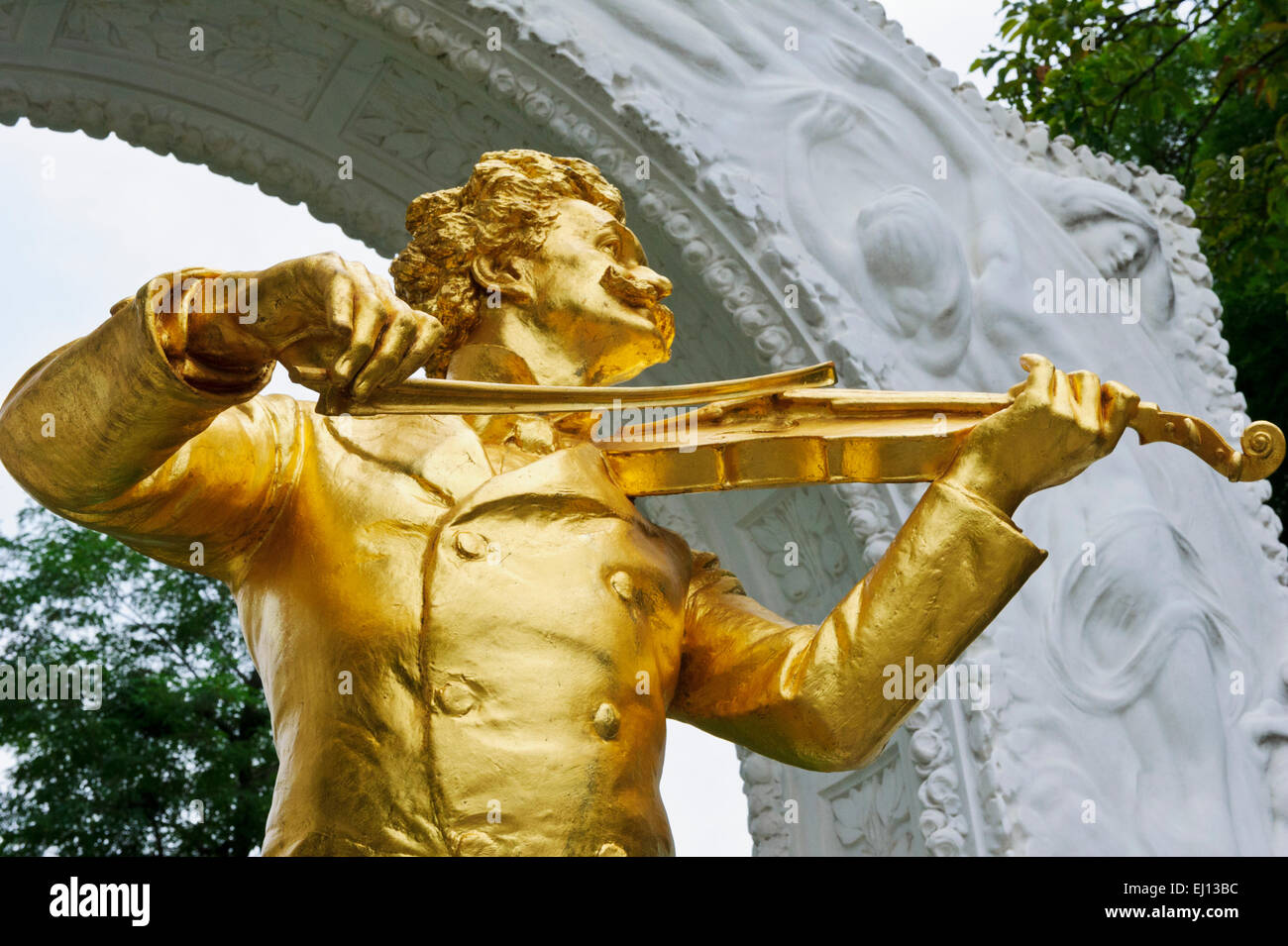 A golden coloured statue of Johann Strauss playing a violin, Vienna ...