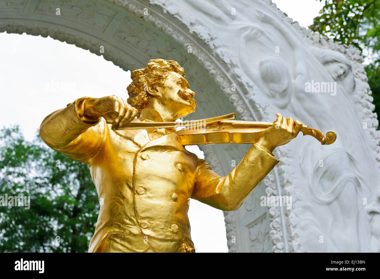 A golden coloured statue of Johann Strauss playing a violin, Vienna ...