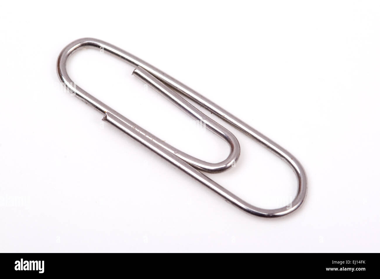 A metal paperclip on a white background Stock Photo - Alamy