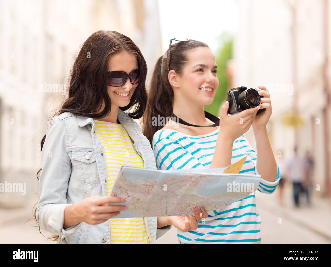 smiling teenage girls with map Stock Photo - Alamy