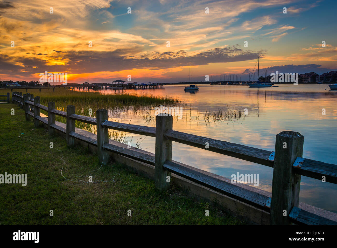 Fence and sunset over the Folly River, in Folly Beach, South Carolina ...