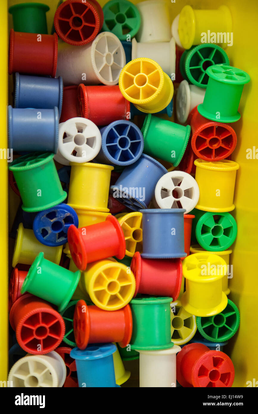 Coloured cotton reels in a UK classroom Stock Photo - Alamy