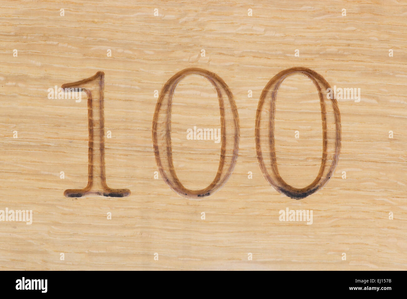 Number 100 carved into wood Stock Photo - Alamy