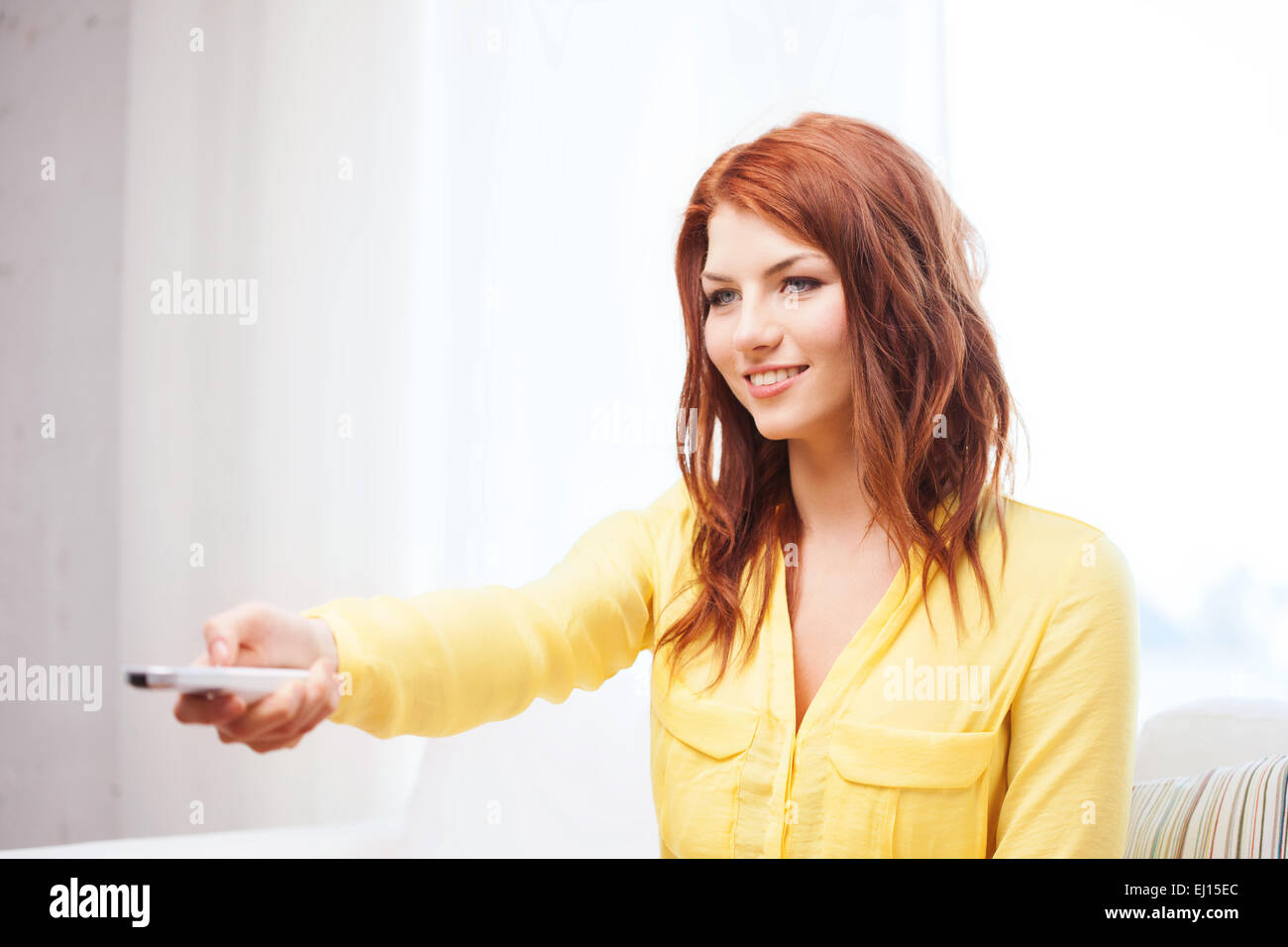Woman sofa remote control hi-res stock photography and images - Alamy
