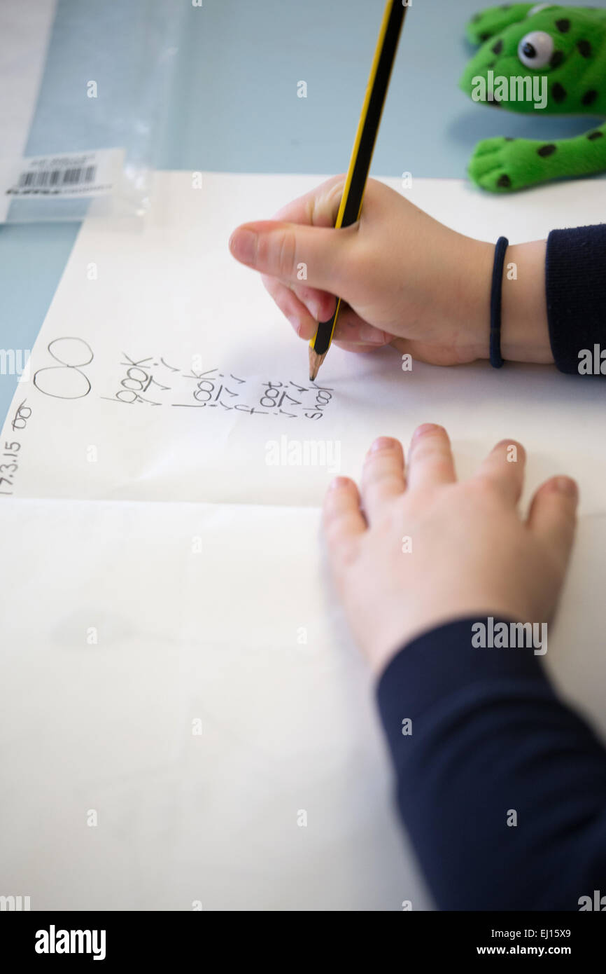 UK primary school child writing in an exercise book Stock Photo - Alamy