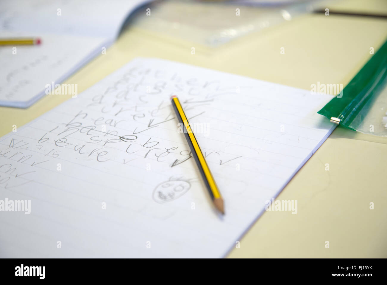 UK primary school child writing in an exercise book Stock Photo - Alamy