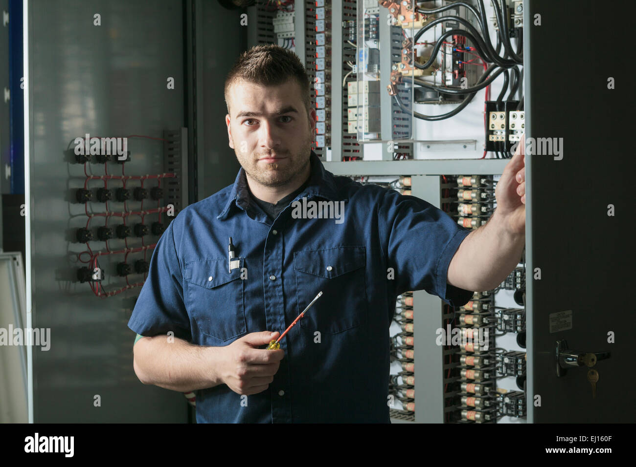 Portrait of an electrician in a room Stock Photo - Alamy