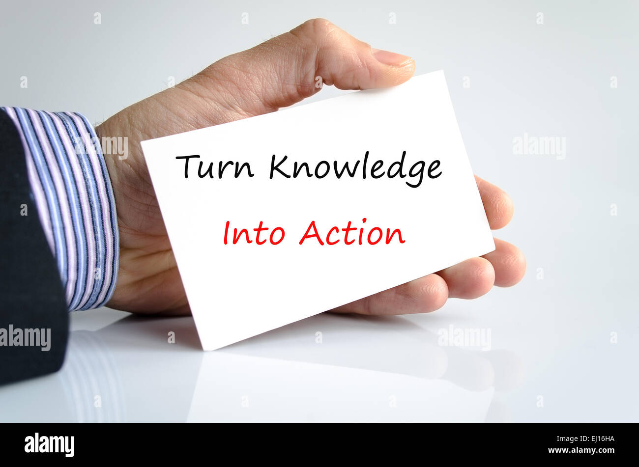 Bussines man hand with text Turn Knowledge Into Action Stock Photo - Alamy