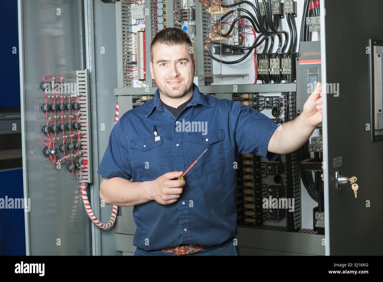 Portrait of an electrician in a room Stock Photo - Alamy