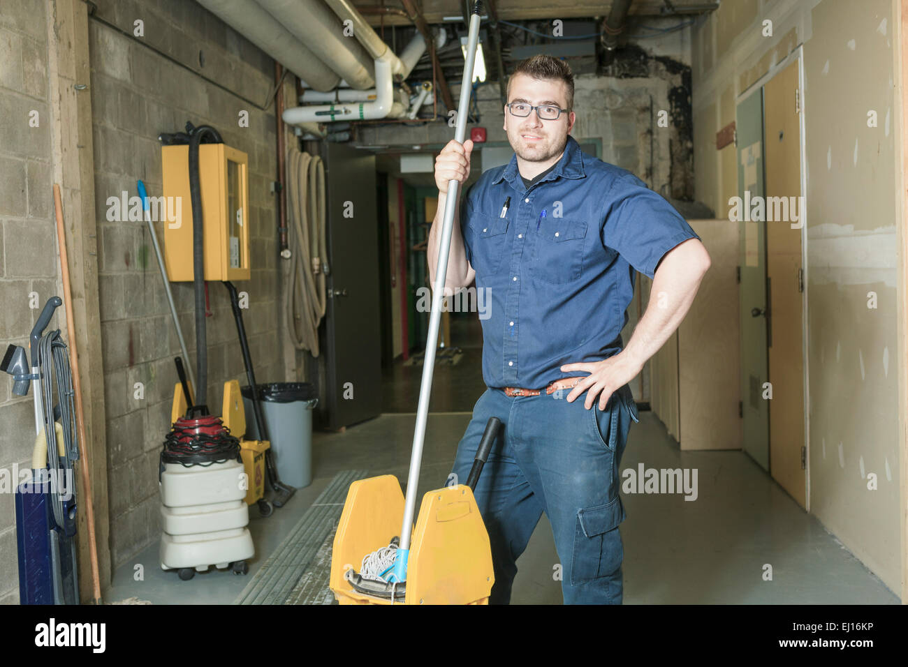 serviceman who cleaning the floor with his mop Stock Photo - Alamy