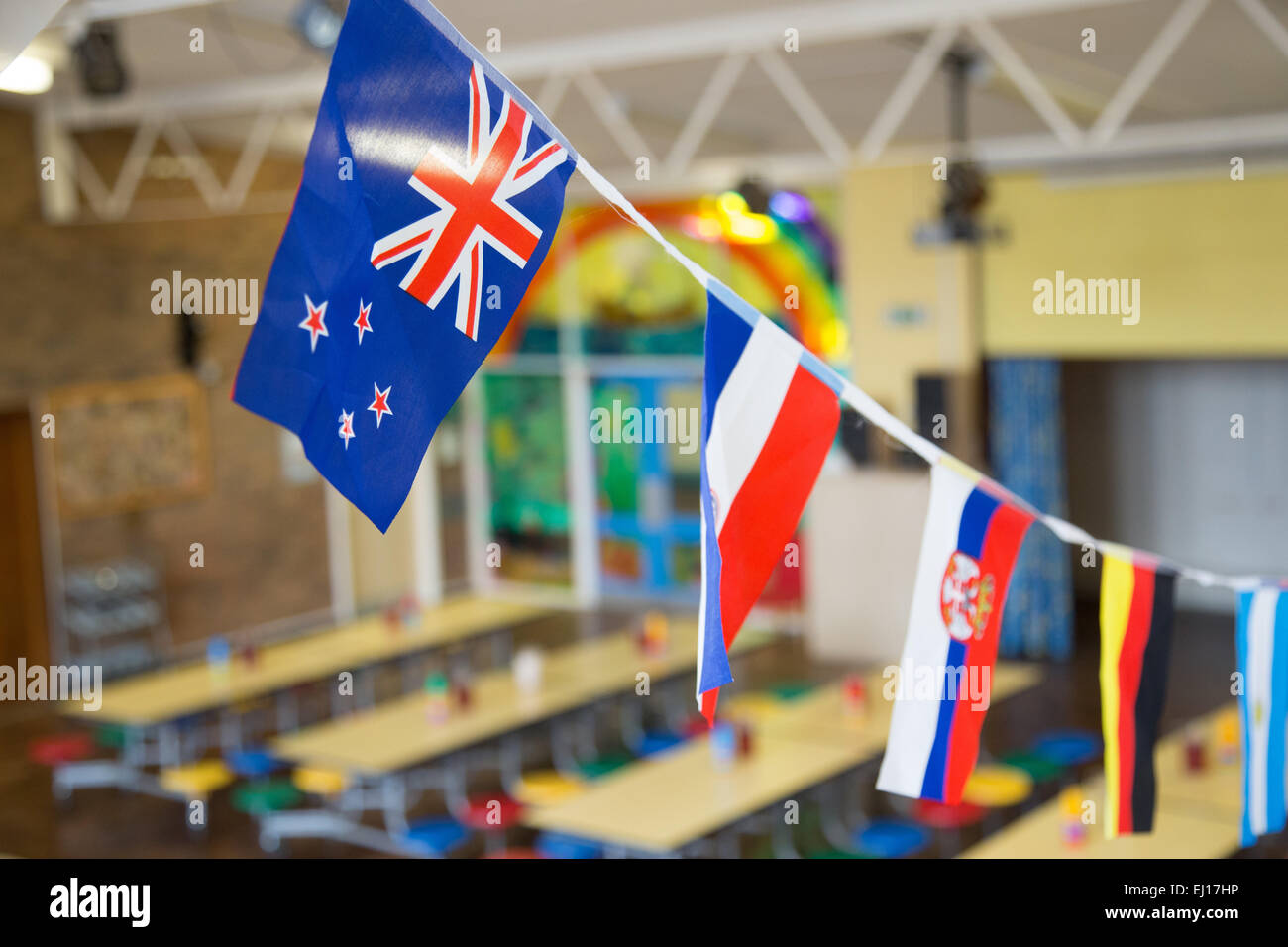 Row of flags in a UK primary school dining hall Stock Photo - Alamy