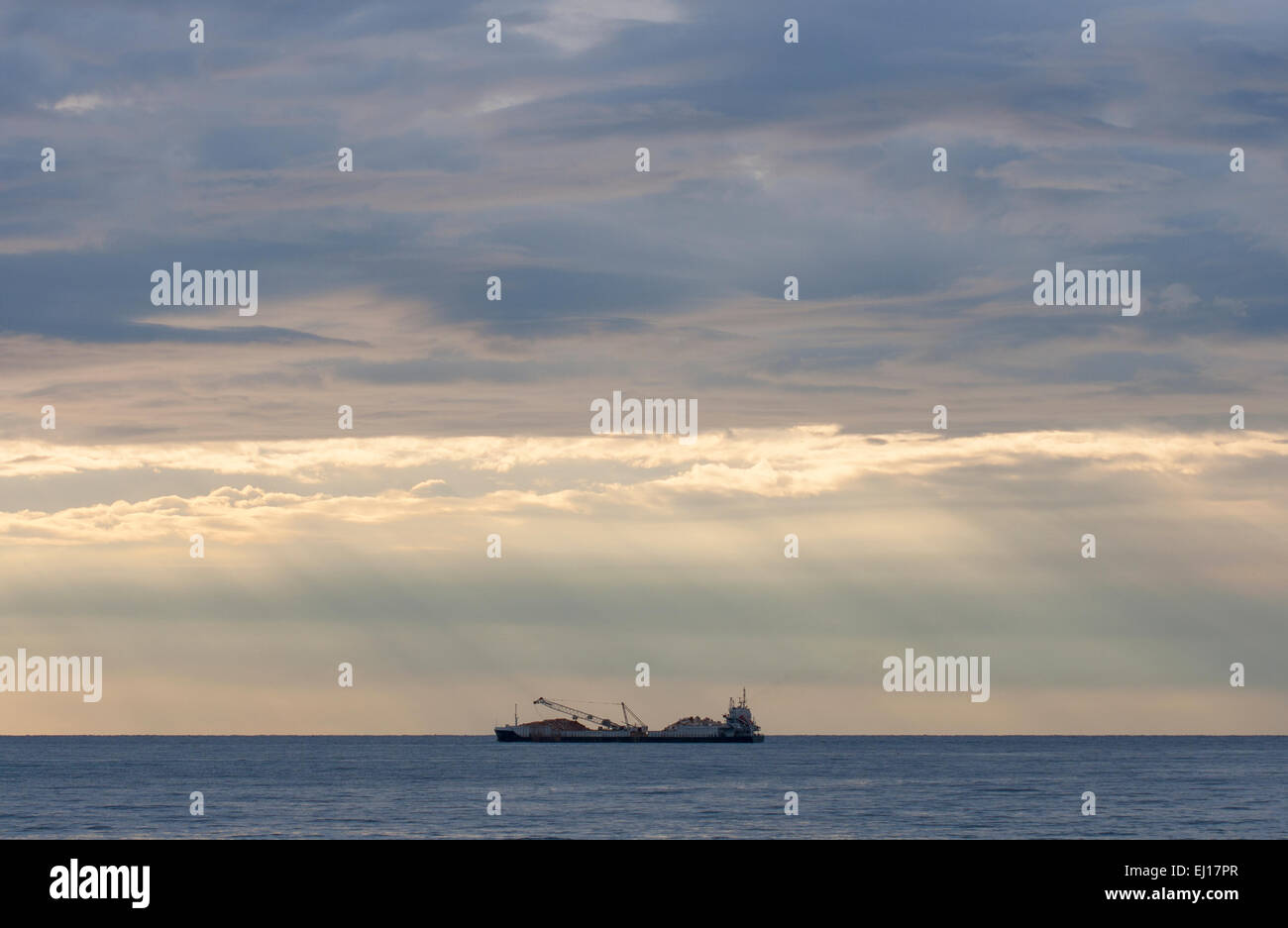 cargo ship loaded with stones at sunset in the Adriatic Sea Stock Photo ...