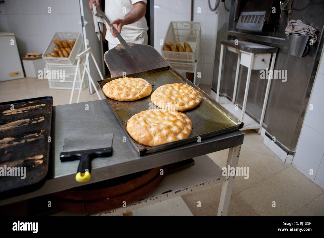 Elaboration process of traditional spanish olive oil pancakes. Baker ...