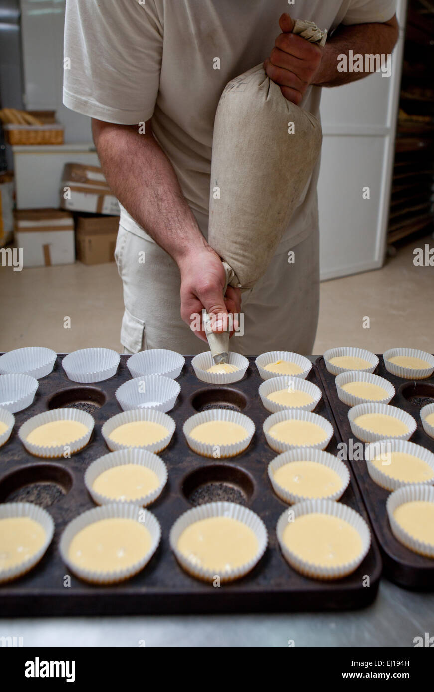 Baking cups being piped. Handmade manufacturing process of spanish ...