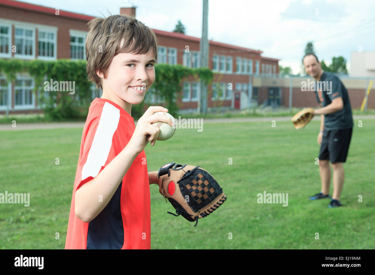Portrait of a young baseball player in a field Stock Photo - Alamy