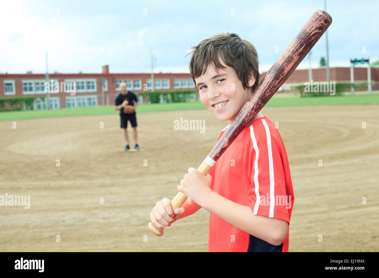 young baseball player in a field Stock Photo - Alamy