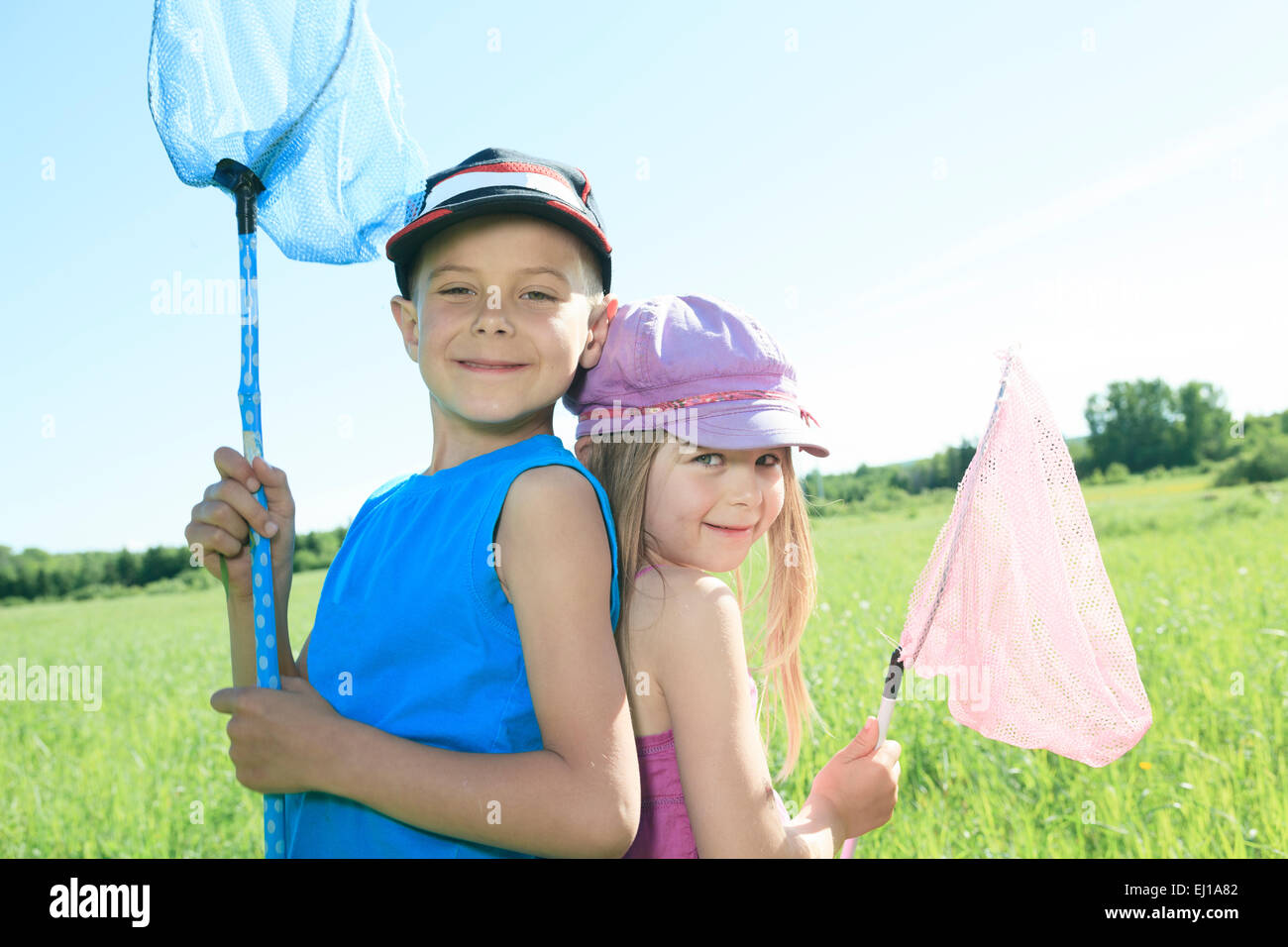 A child who try to catch some butterfly with net Stock Photo - Alamy