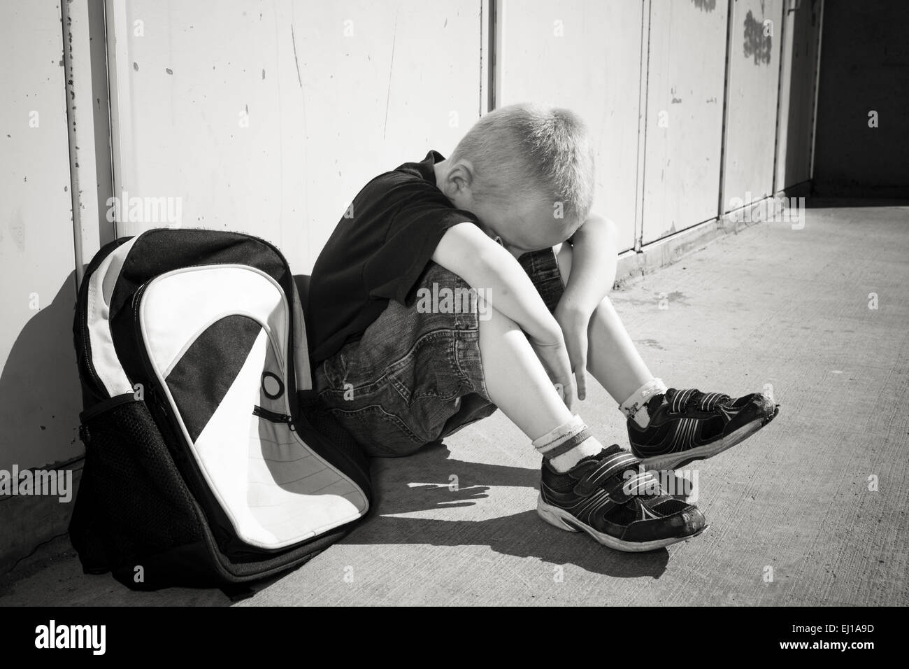 A boy bullying in school playground Stock Photo - Alamy