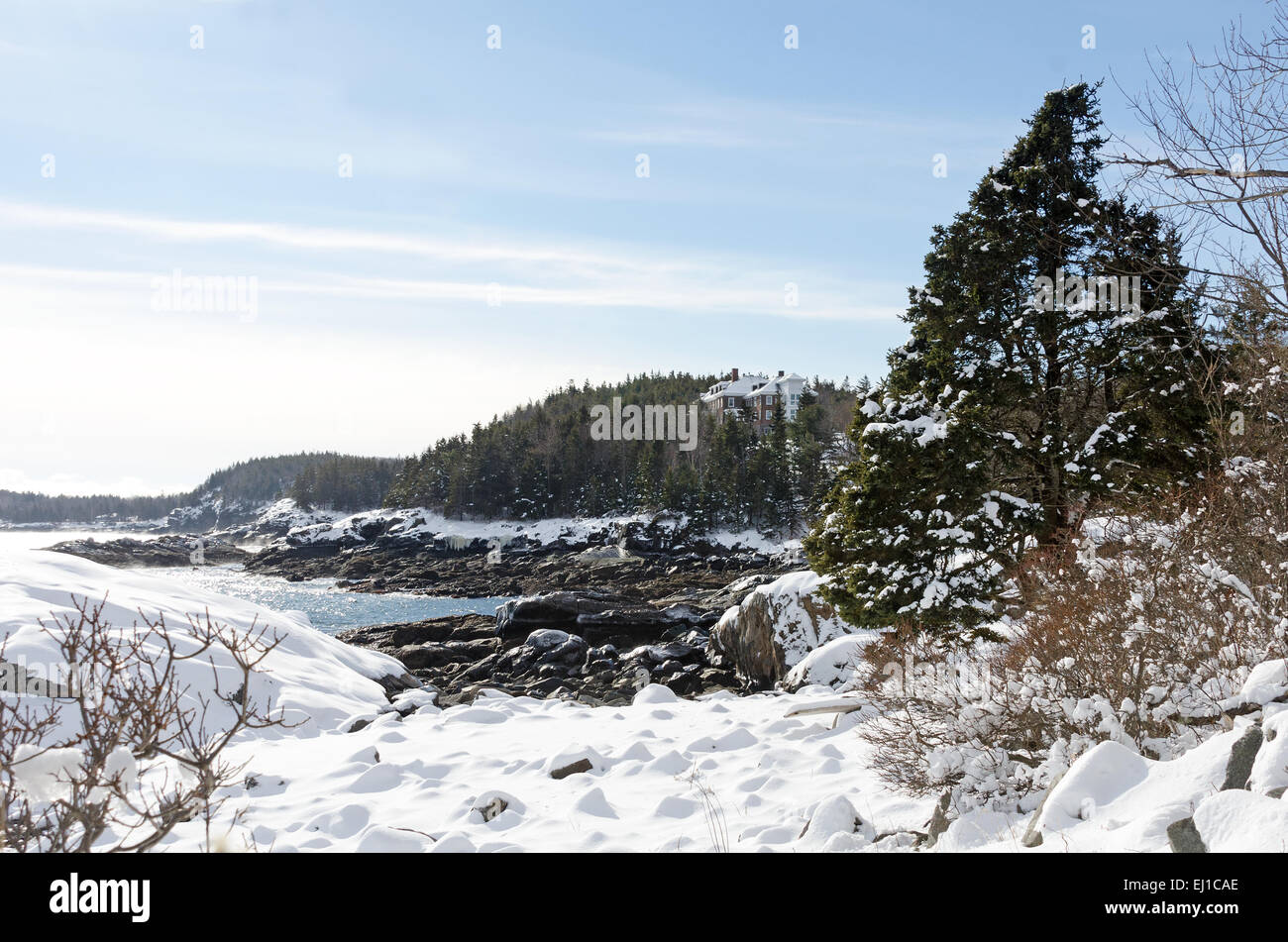 Snow blankets the shore of Acadia National Park, Bar Harbor, Maine. The ...