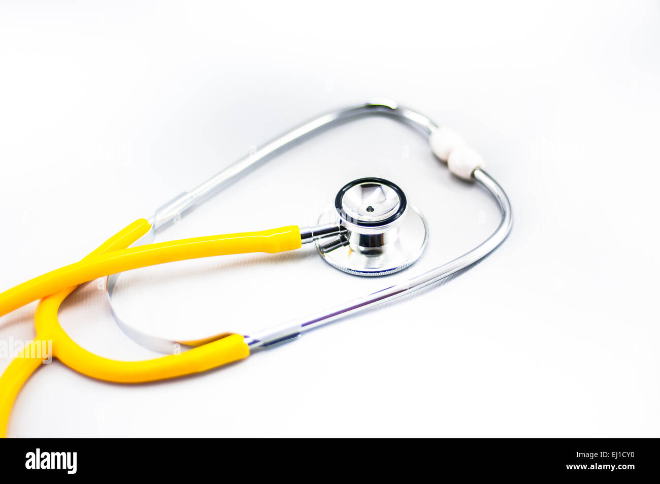 Yellow stethoscope with isolated white Stock Photo - Alamy