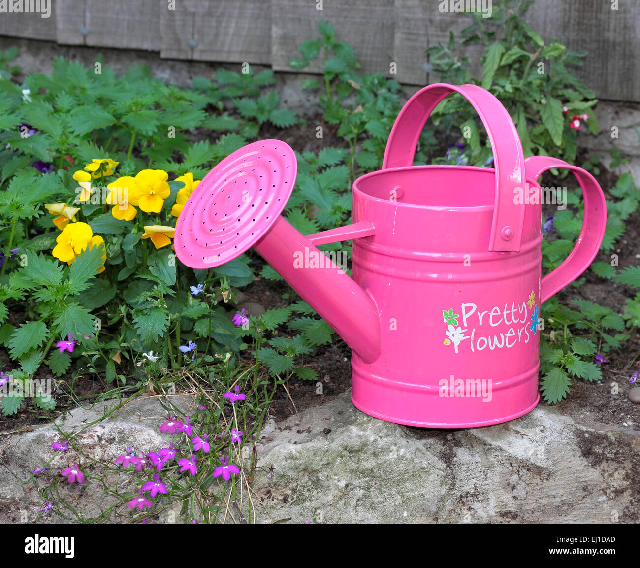 Child's pink watering can with the words Pretty Flowers written on the ...