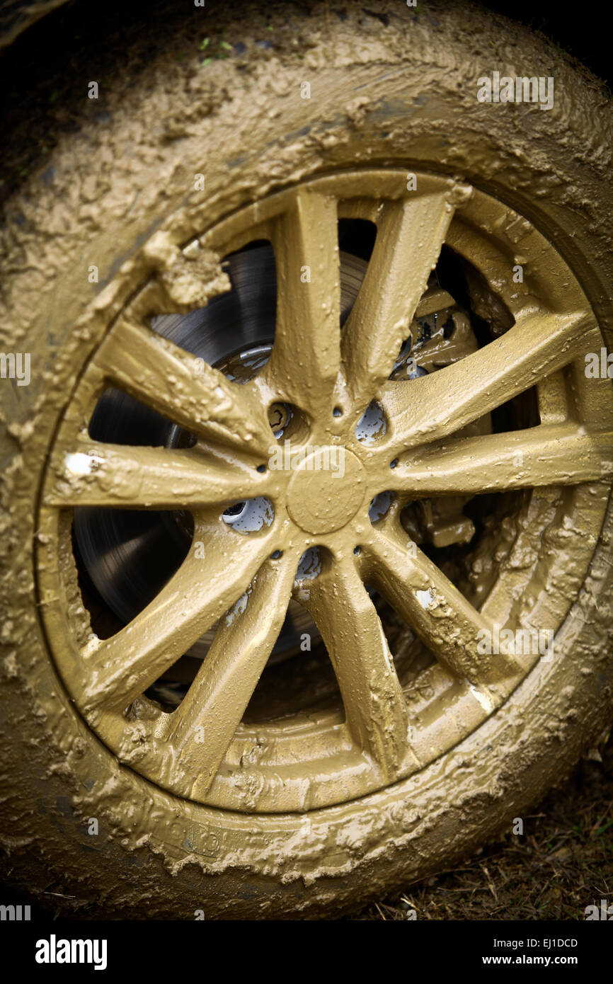 Color detail shot of an off-road car's wheel, covered in mud Stock ...
