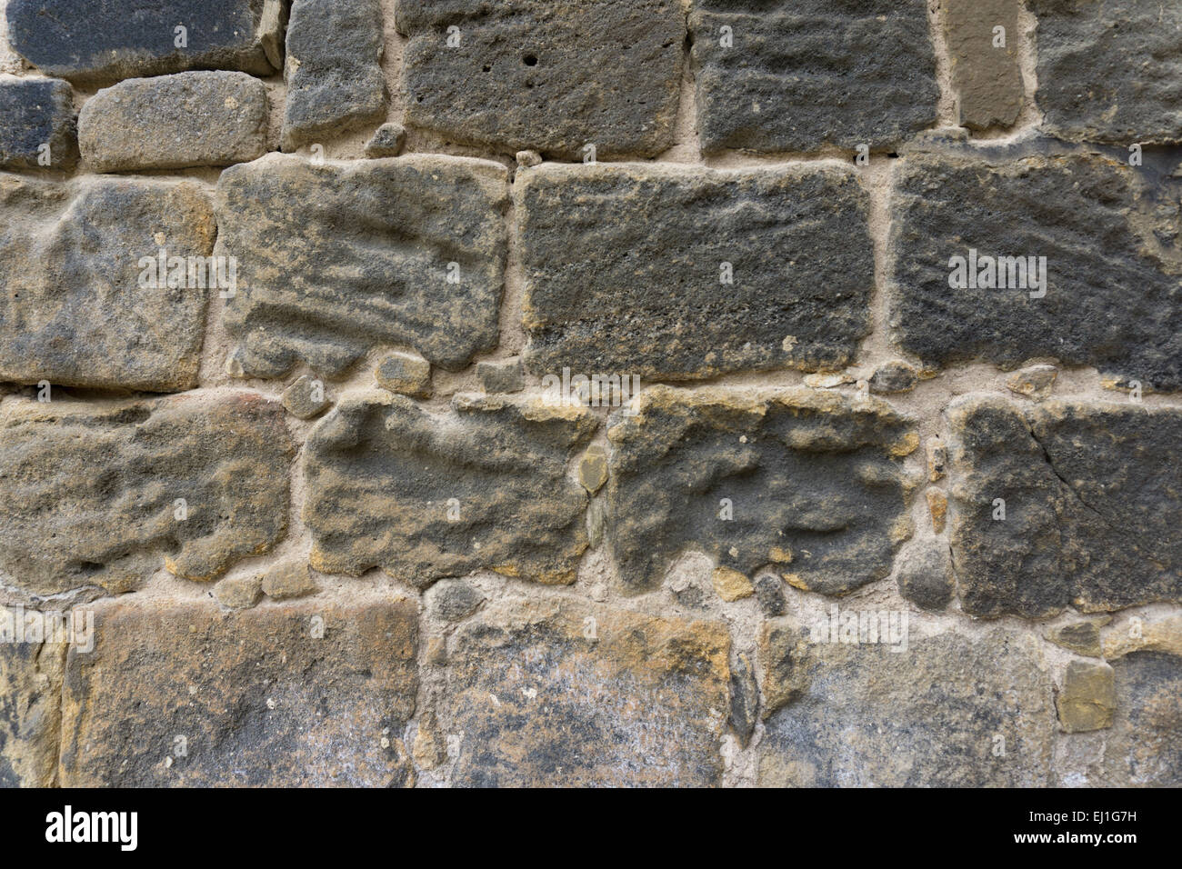 Close up detail of an old brown Bramley Fall gritstone stone wall at ...