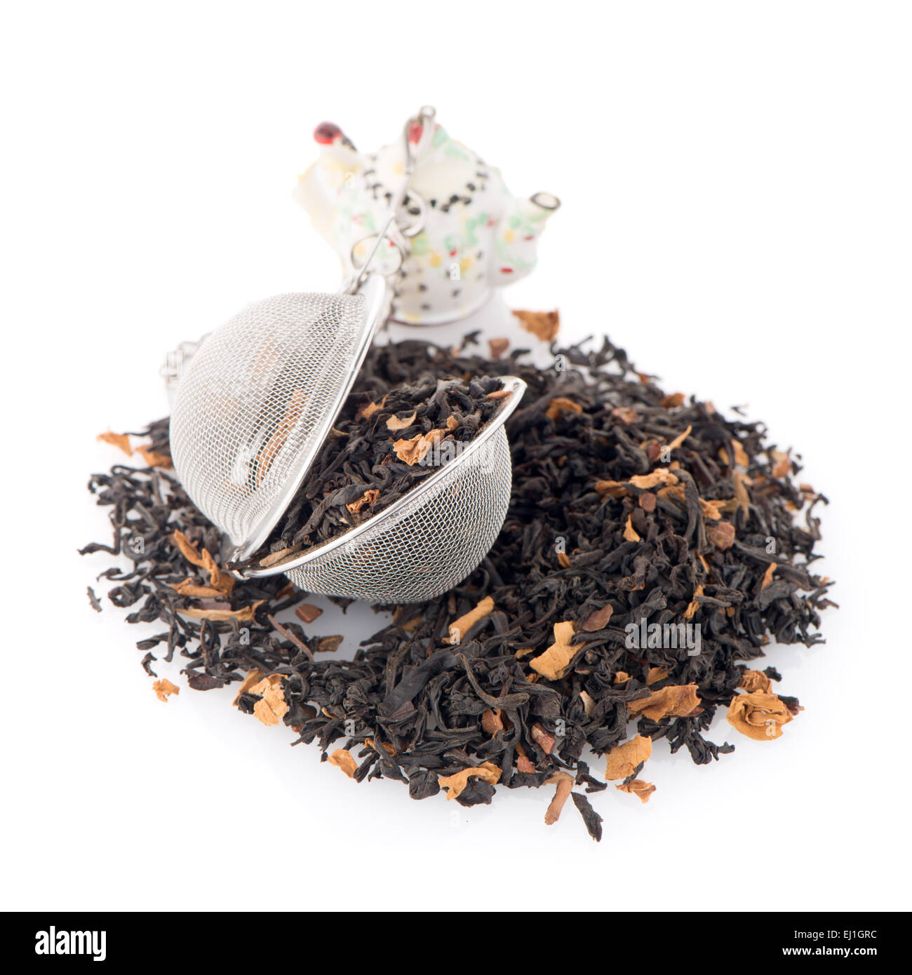 Aromatic black dry tea with petals and a tea strainer on white ...