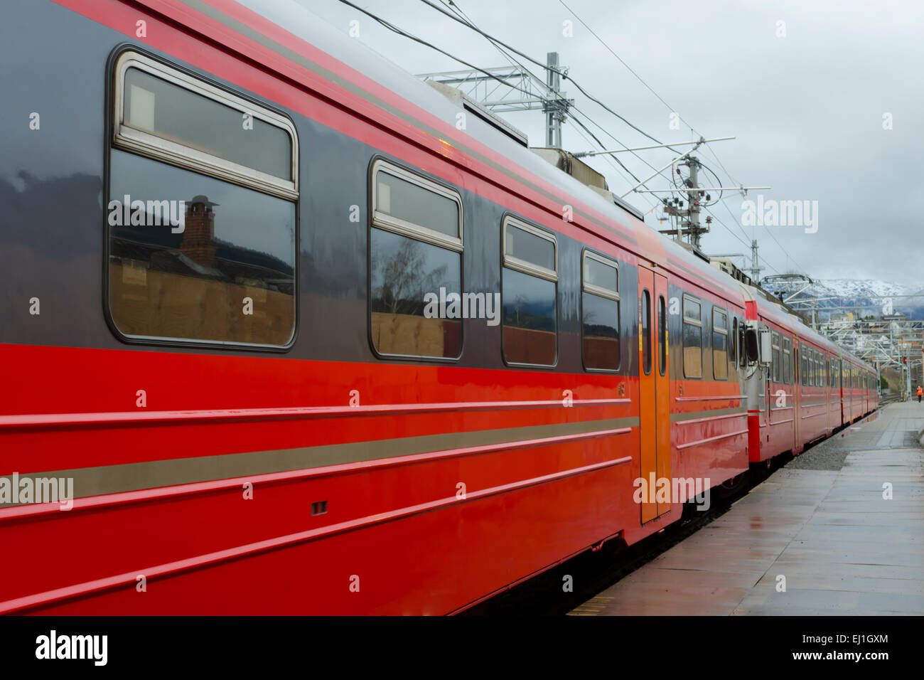 red train at a station Stock Photo - Alamy