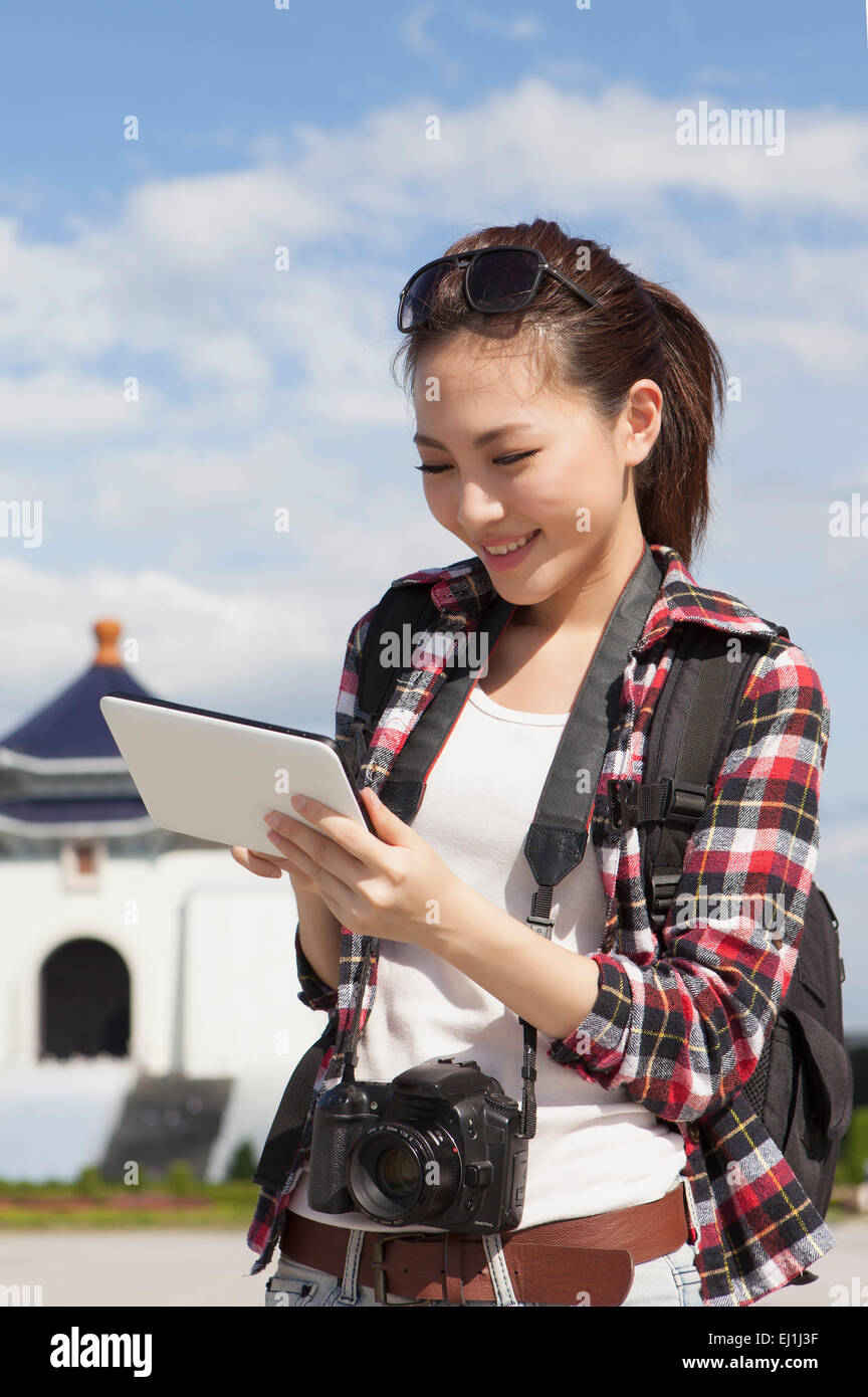 Young woman holding touch pad and looking down with smile Stock Photo ...