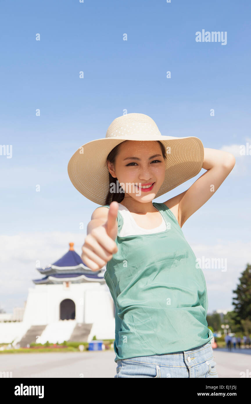 Young woman pointing and smiling at the camera Stock Photo - Alamy