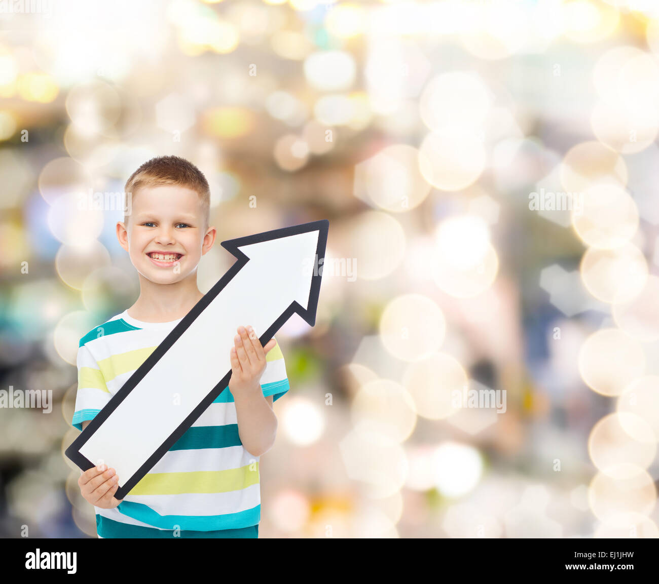 smiling little boy with blank arrow pointing right Stock Photo - Alamy