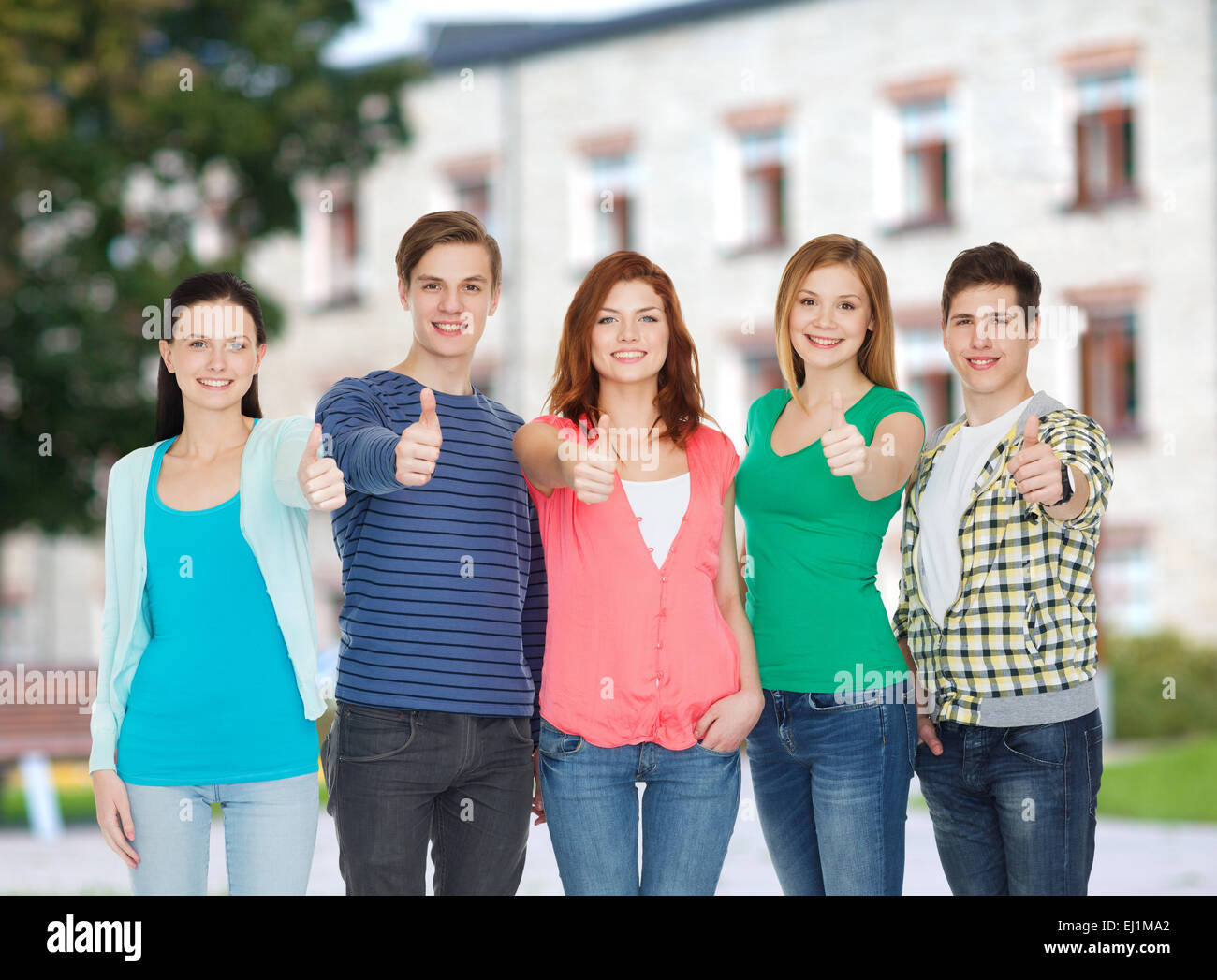 group of smiling students showing thumbs up Stock Photo - Alamy